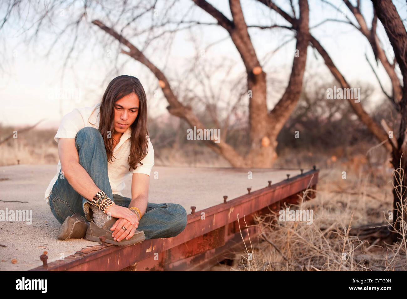 Handsome young man with long hair in an outdoor setting Stock Photo - Alamy