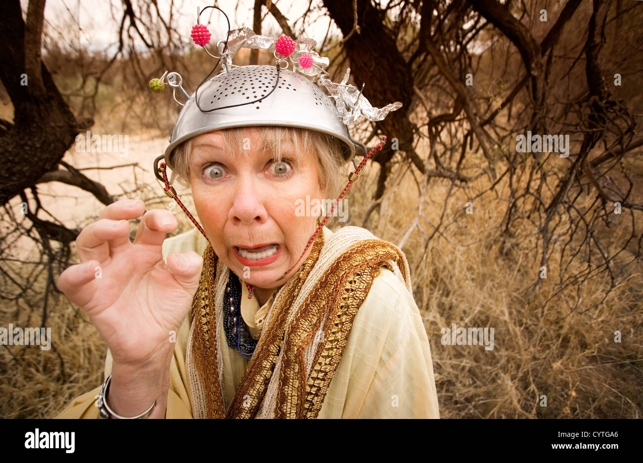 Crazy woman wearing a metal colander for a helmet Stock Photo - Alamy