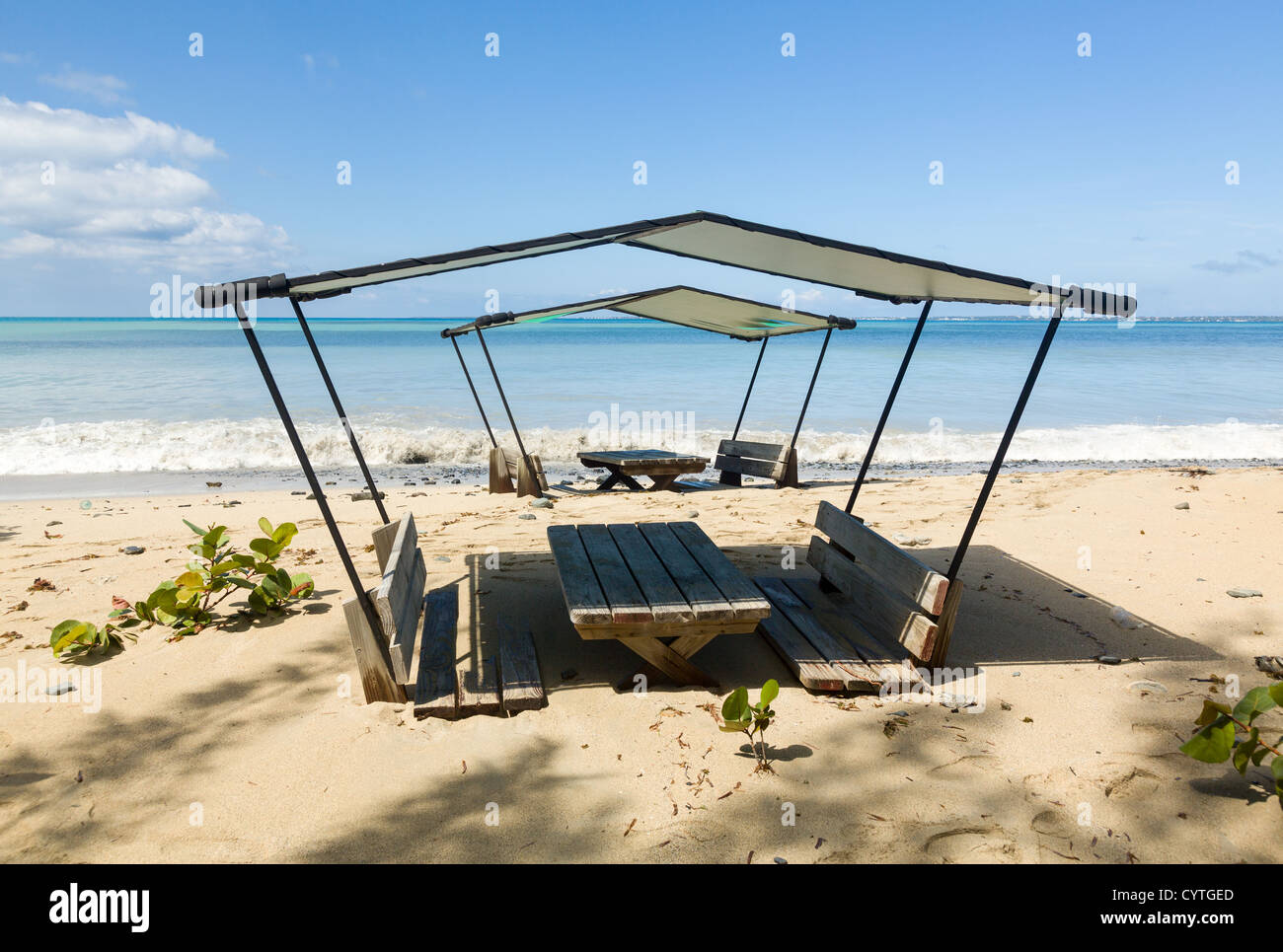 Sand swamping bar seats and table and serving area on Friars bay in St ...