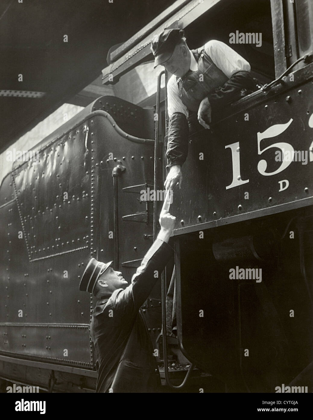 Train conductor giving paper to train engineer Stock Photo - Alamy