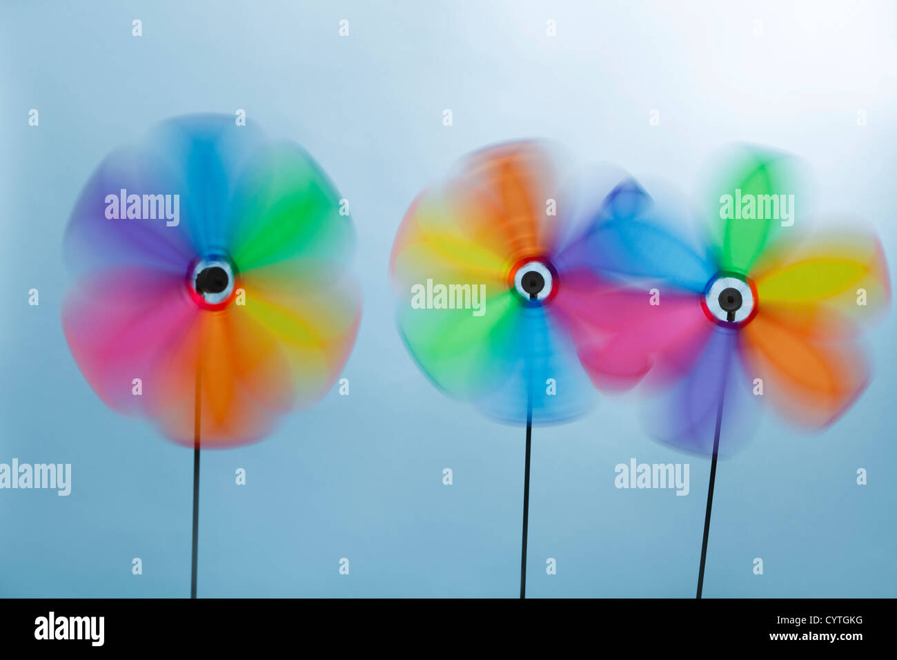 Pinwheels in motion against blue background in a studio Stock Photo - Alamy
