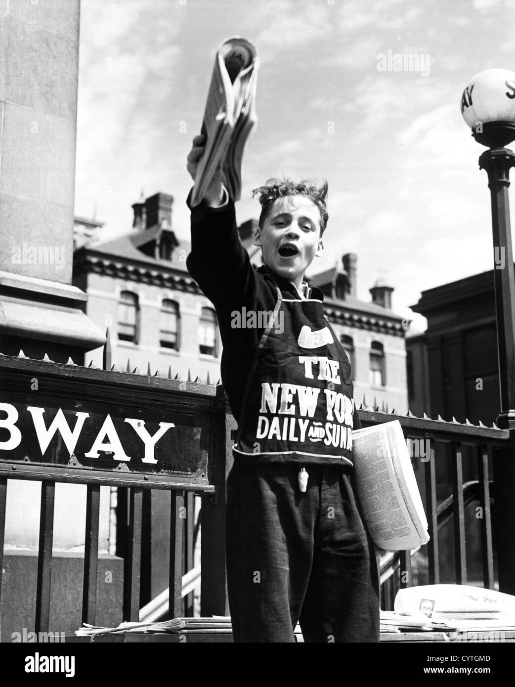 Paperboy standing in street selling papers Stock Photo - Alamy