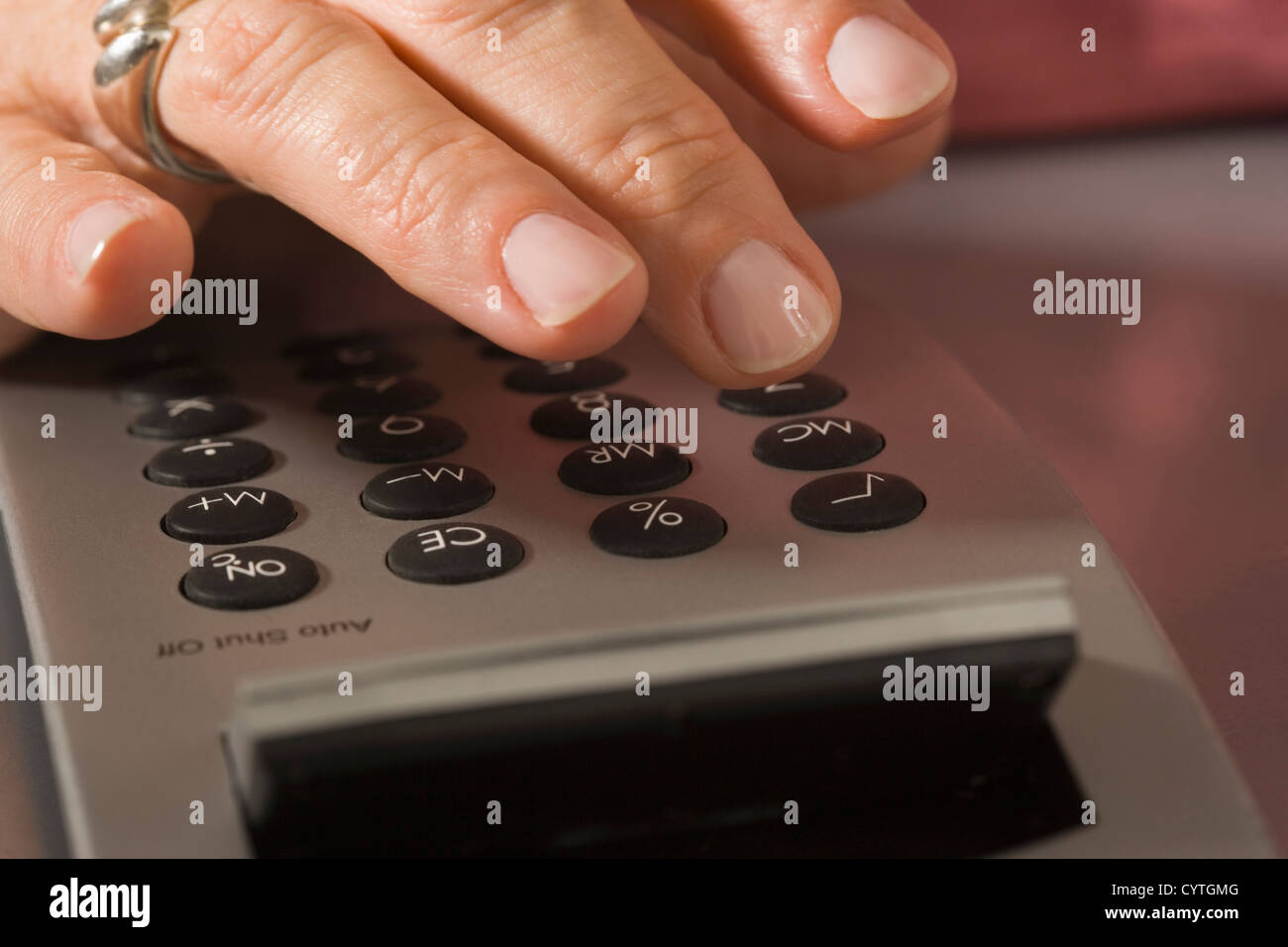 Woman's hand using calculator, Extreme Close Up Stock Photo - Alamy