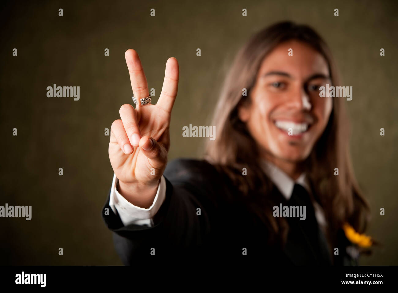 Handsome Man In Formal Jacket With Boutonniere Making Peace Sign Stock