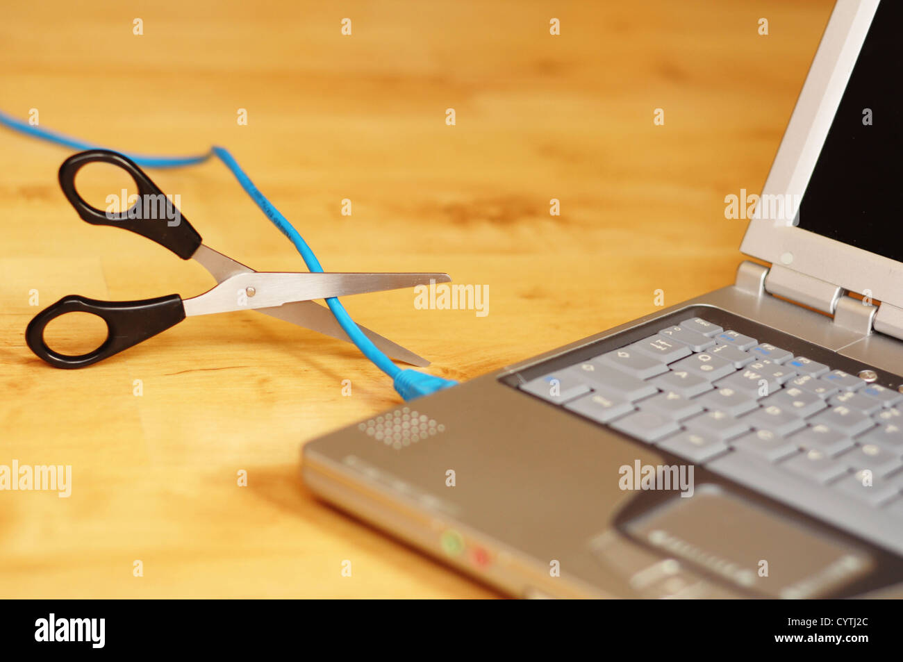 wireless network or wlan concept with laptopn scissors and cable Stock ...