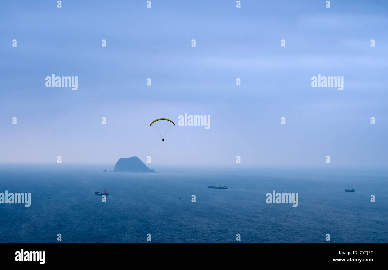 It is a kind of sport called parachuting over the sea Stock Photo - Alamy