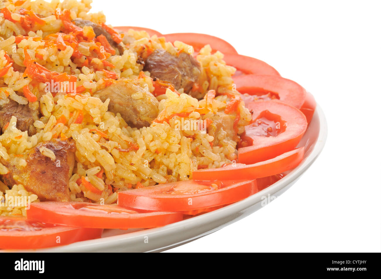 Rice with meat on a plate isolated on white background Stock Photo - Alamy