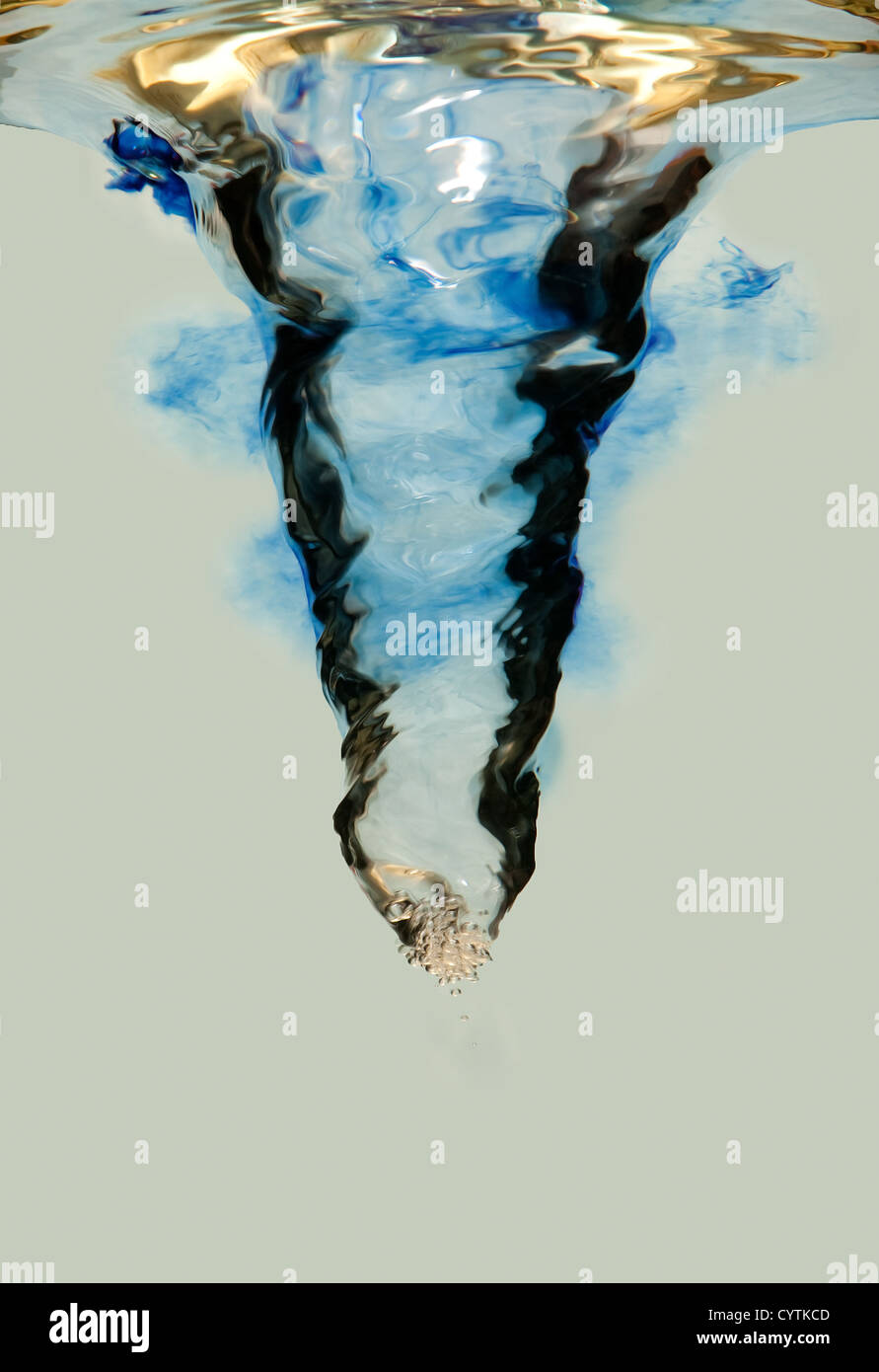 Side view of an underwater vortex swirl with bubbles and blue ink cloud ...