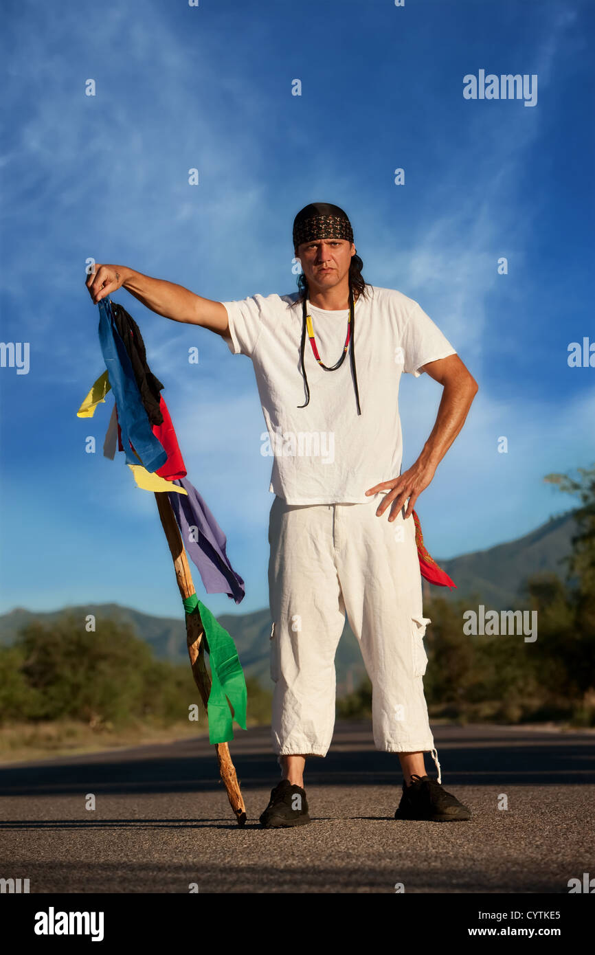 Native American man in the middle of a road with flags representing ...