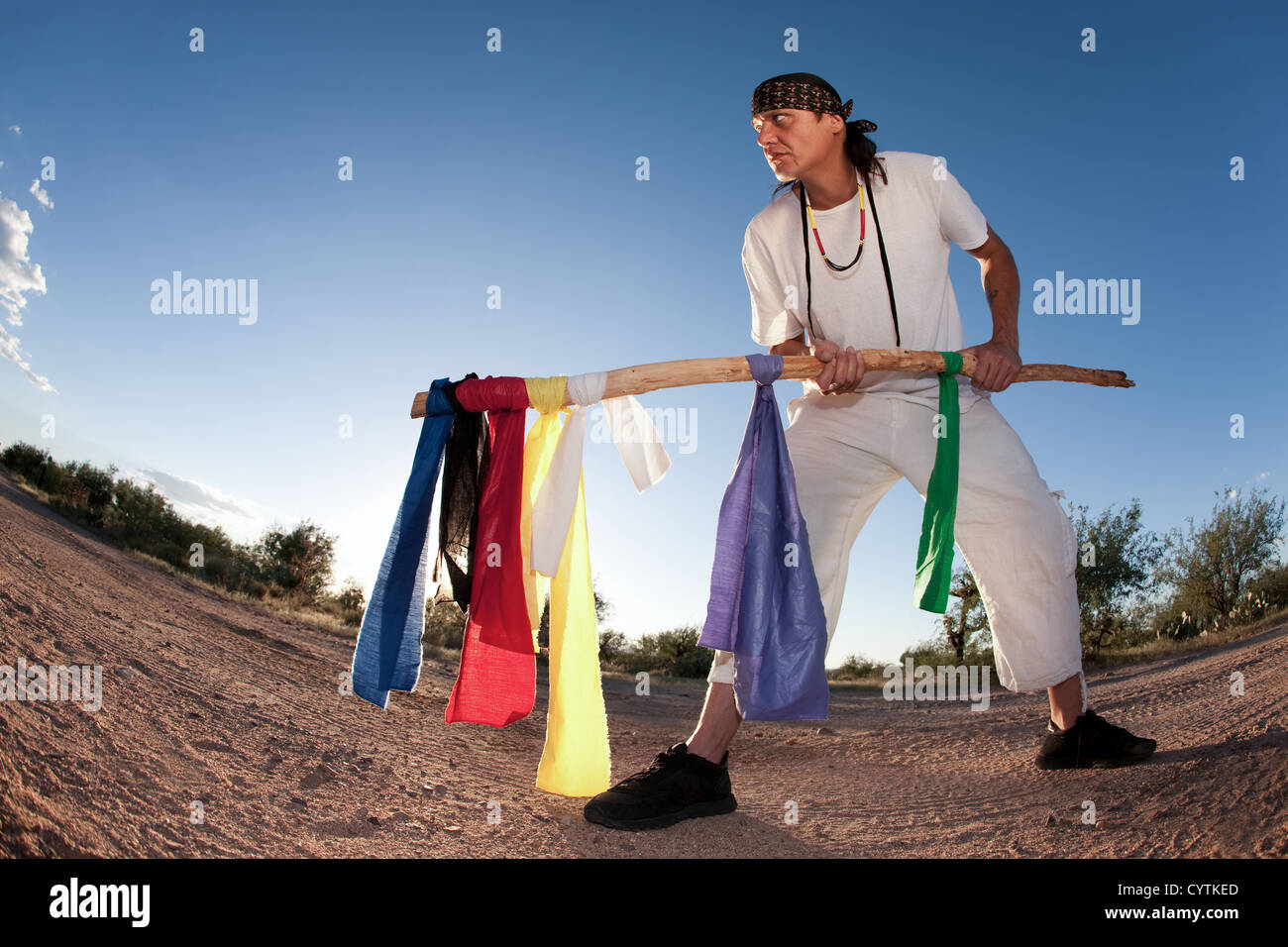 Native American man with colorful flags representing seven directions ...