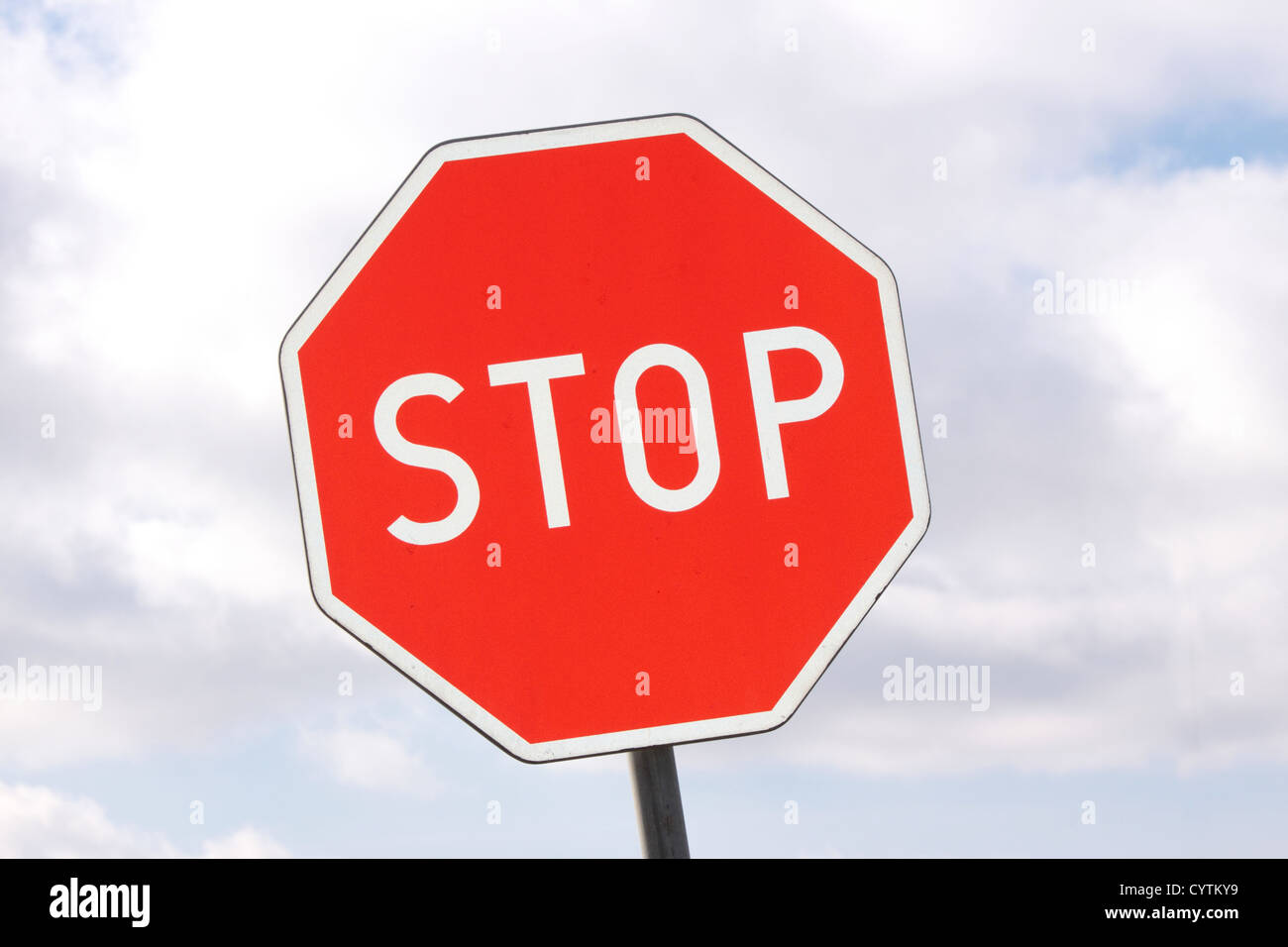 Road sign - stop - on cloudy sky background Stock Photo - Alamy