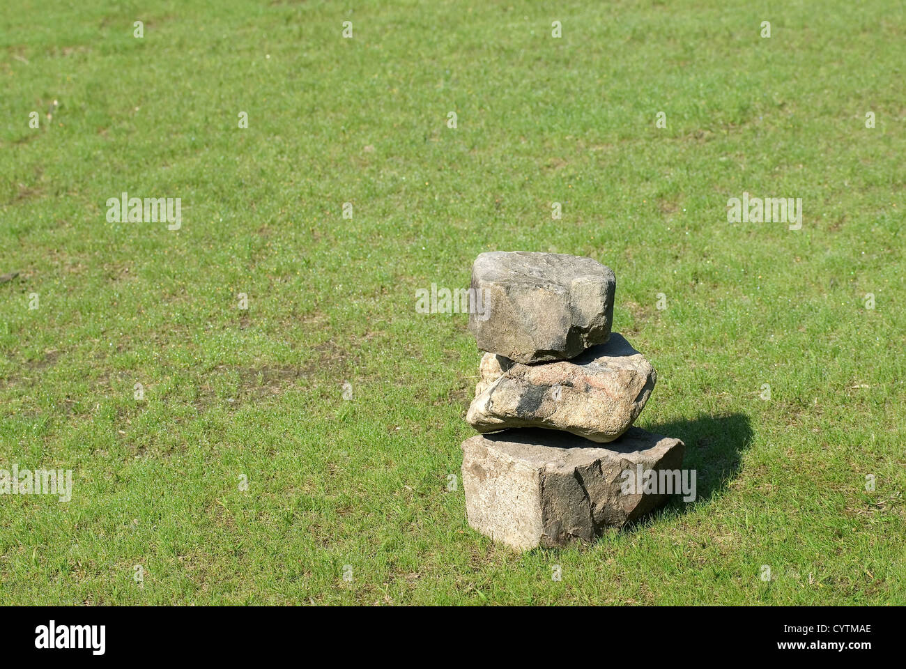 There were tree stones on a grassland Stock Photo - Alamy