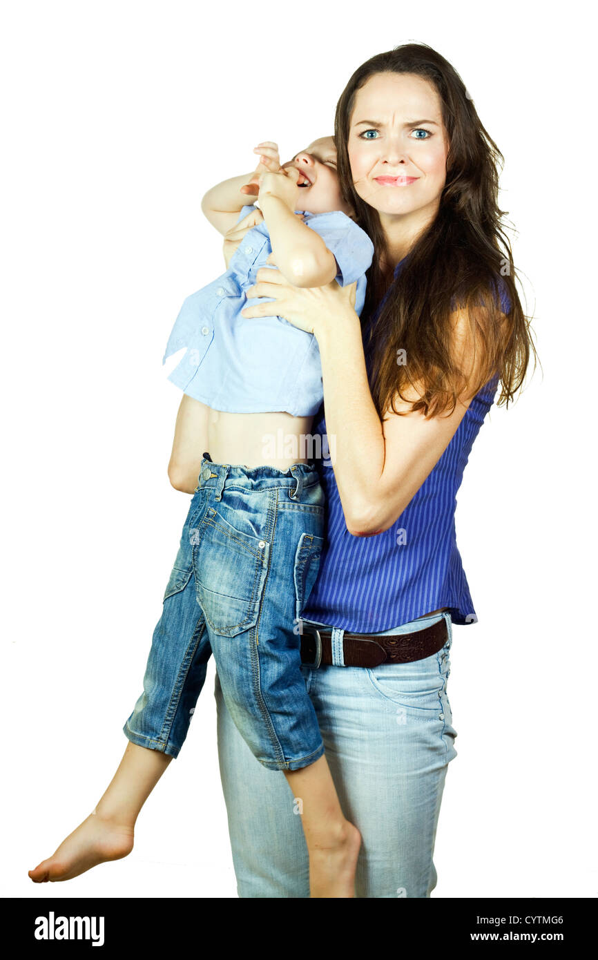 A young mother holding a screaming and squirming toddler Stock Photo ...