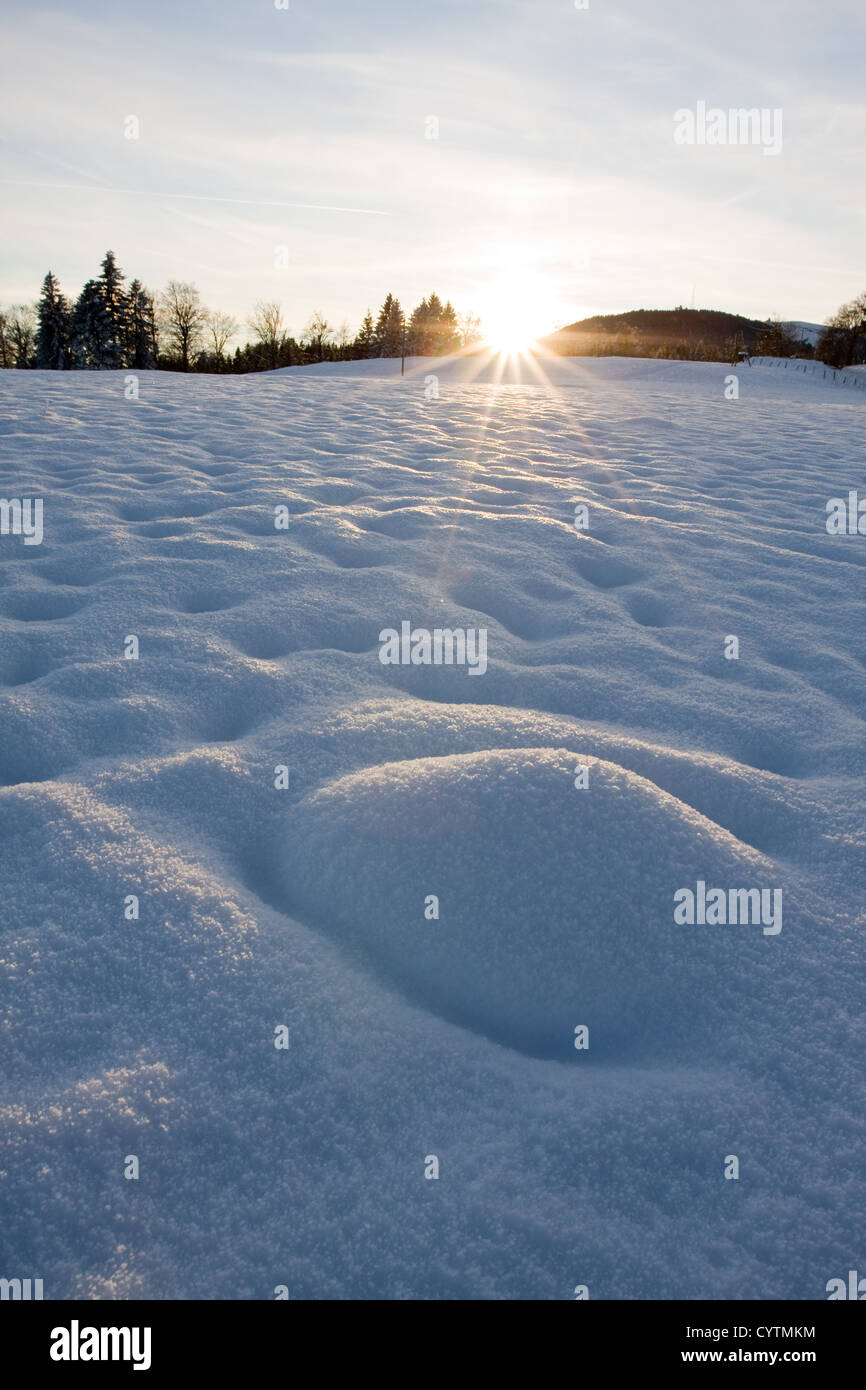 Sunrise or sunset against a snow covered landscape, winter background ...