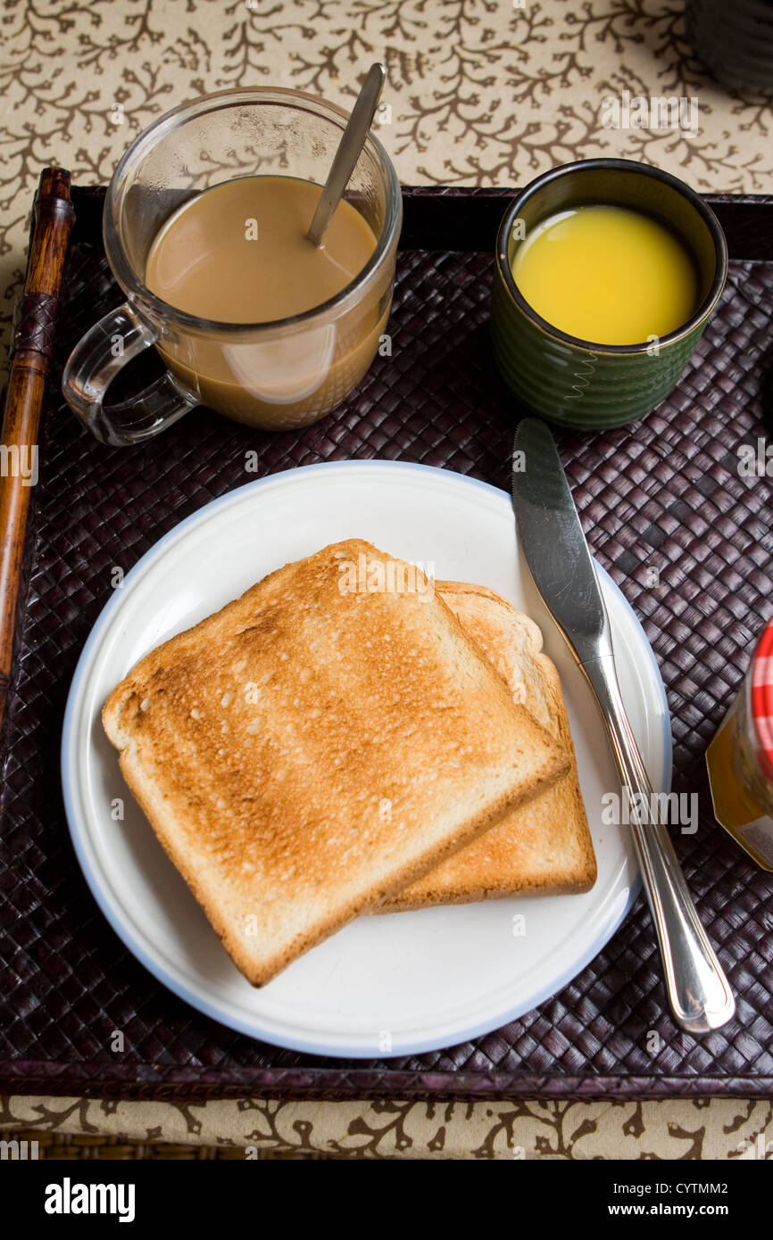 Breakfast meal with toast bread, coffee, orange juice, apples ...
