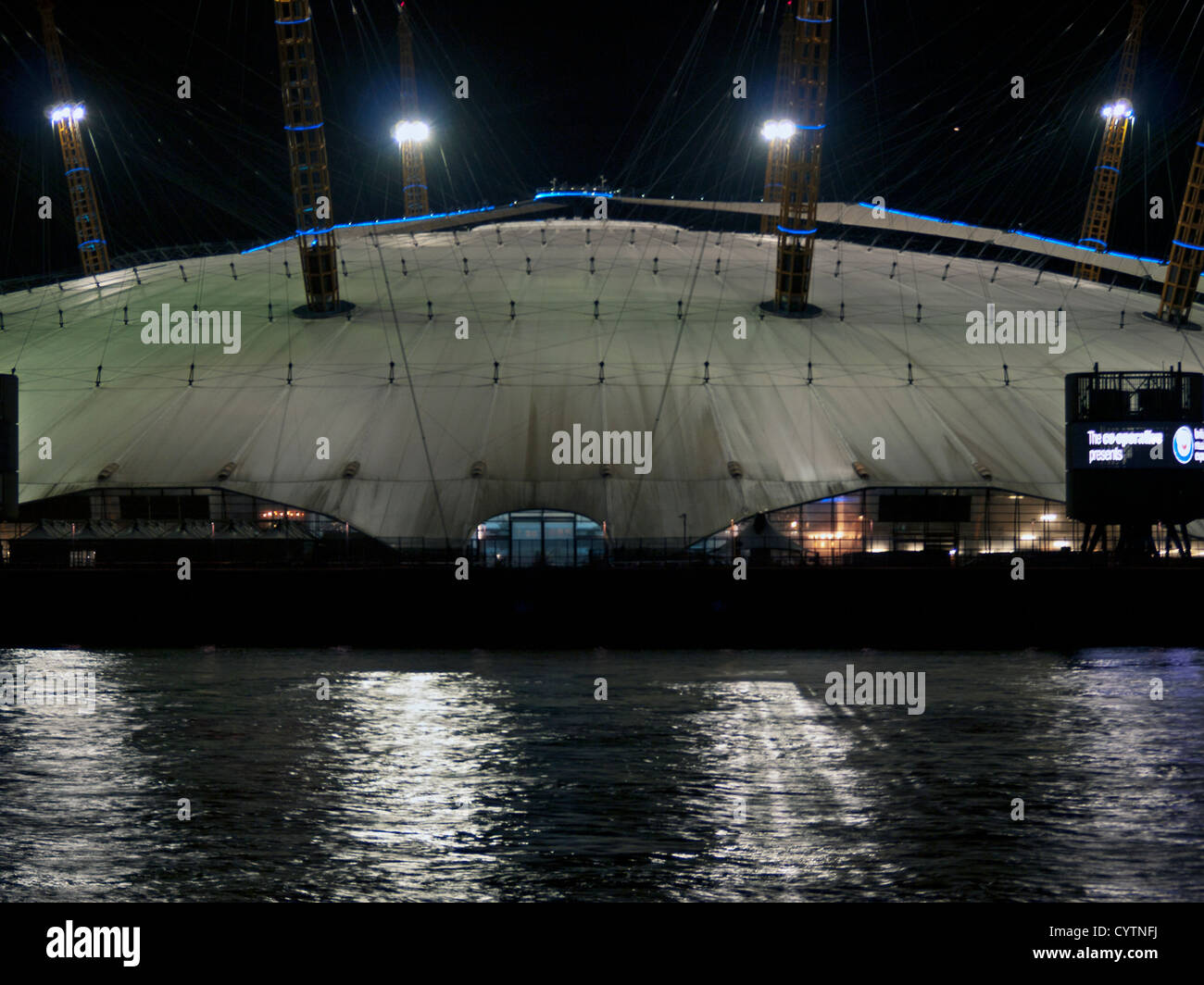 Night view of 02 Arena showing illuminated walkway and the River Thames ...