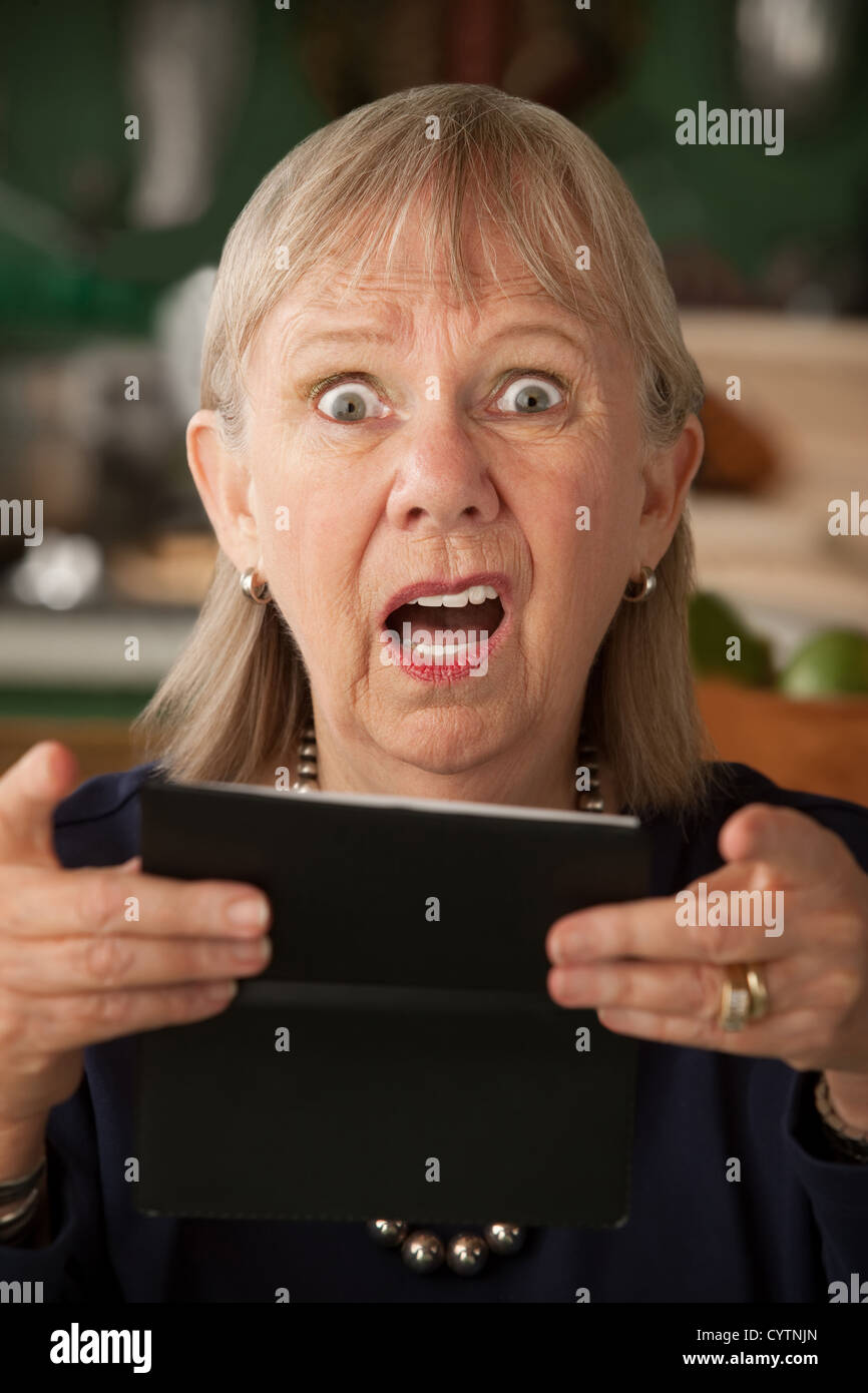 Senior woman at home with checkbook Stock Photo - Alamy