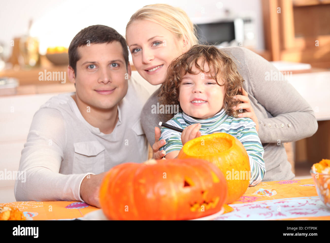 Family carving a pumpkin together Stock Photo - Alamy