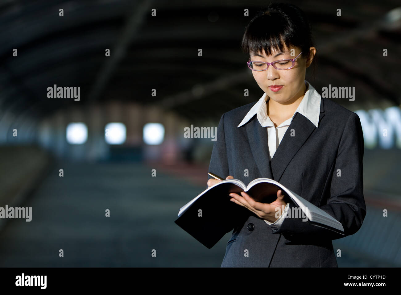 Young asian business woman standing holding journal or report Stock ...