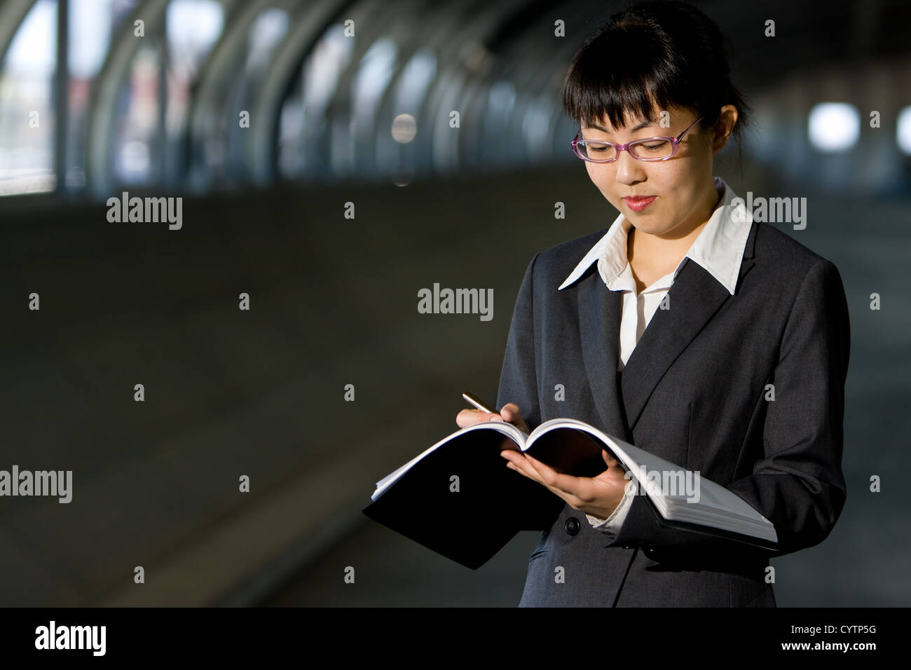 Young asian business woman standing holding journal or report Stock ...