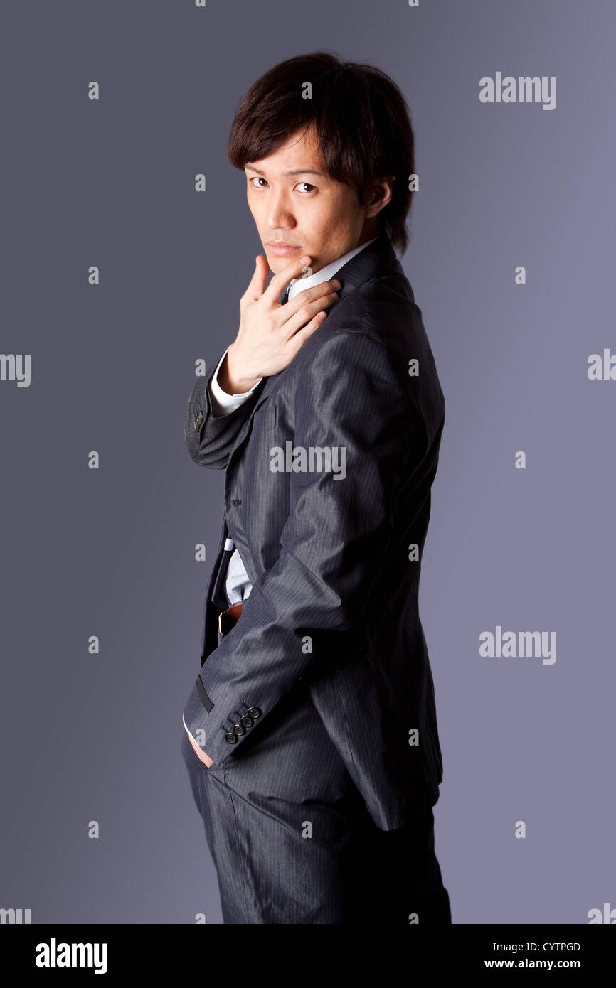 Successful Asian business man thinking Stock Photo - Alamy