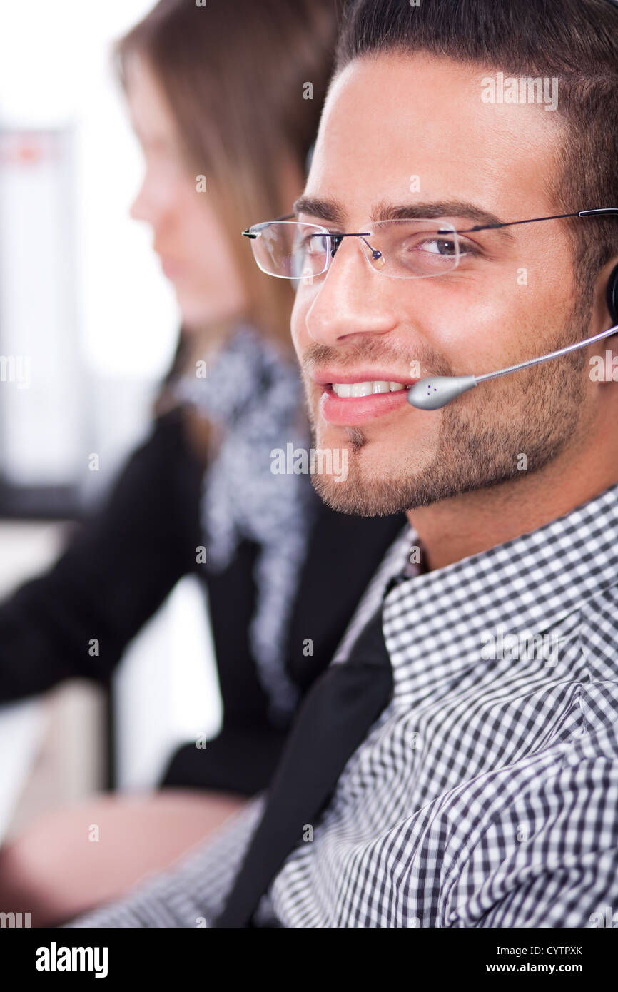 Business executive servicing the customer through head phone with ...