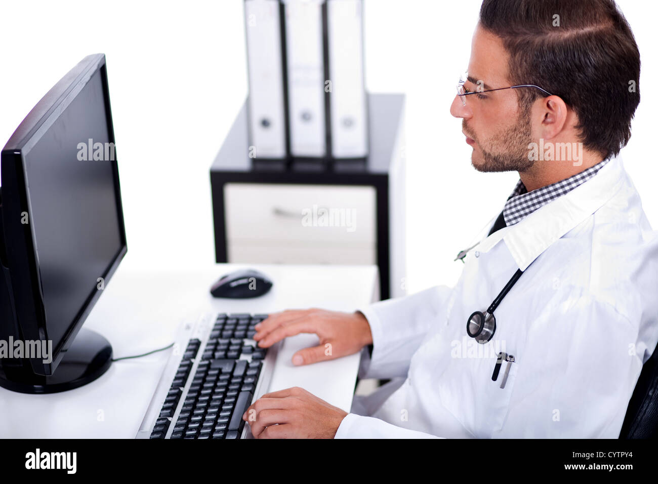 male doctor working with desktop at his desk over white background ...
