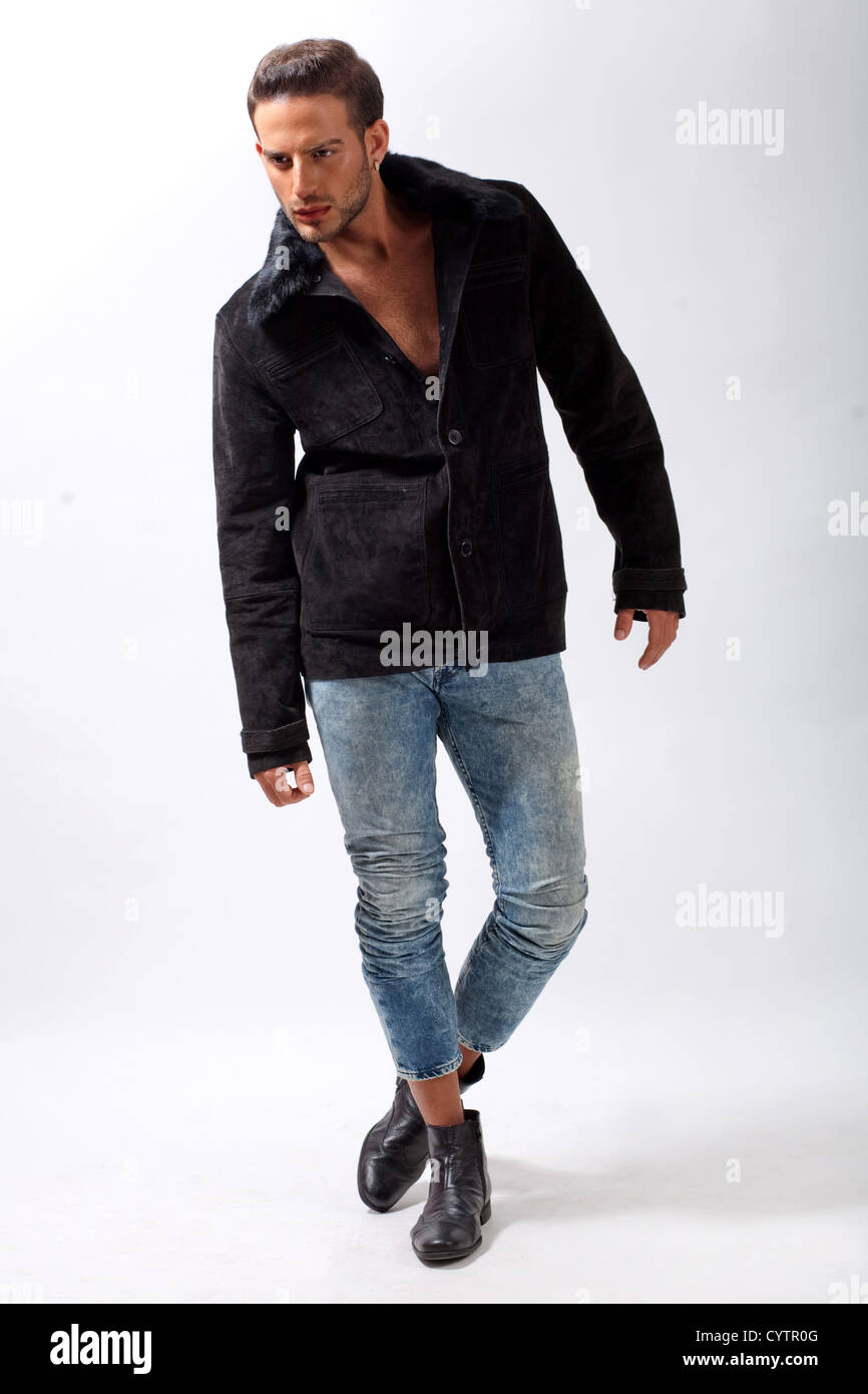 Handsome male model with black jacket on a isolated grey background ...