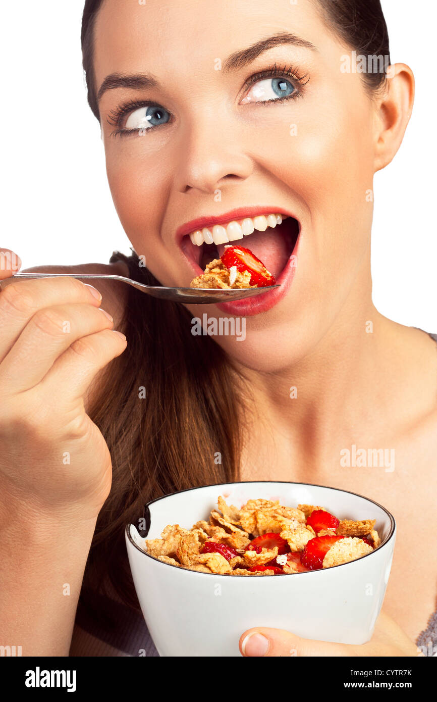 A close-up portrait of a beautiful young woman eating a healthy bowl of ...