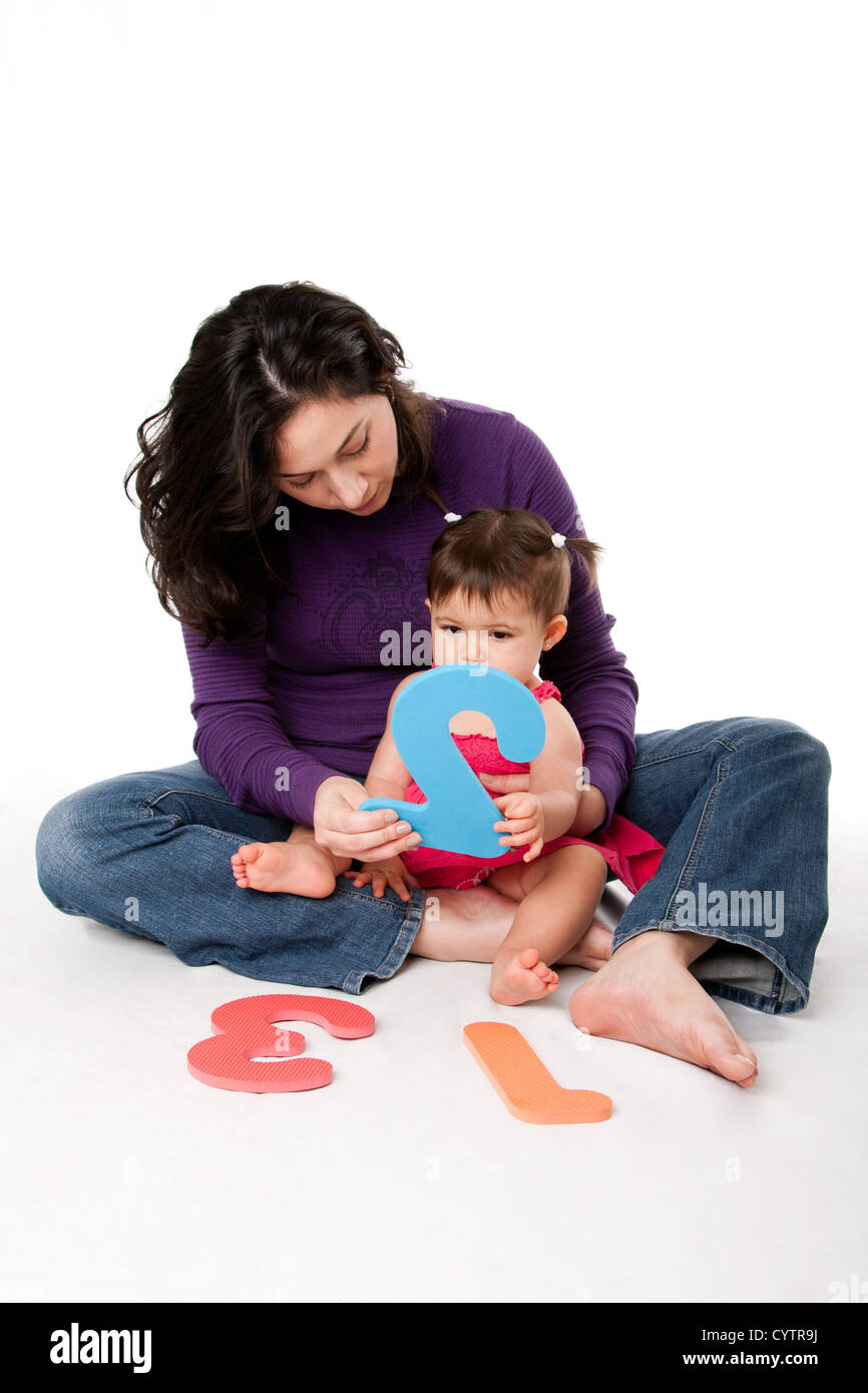 Mother, nanny, or teacher teaching baby to learn how to count one, two ...