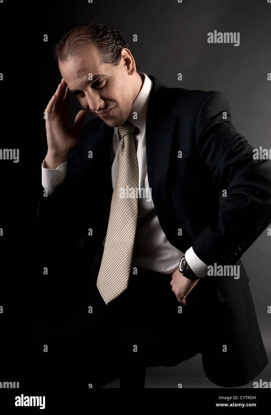 adult businessman serious thinking sitting on dark background Stock ...