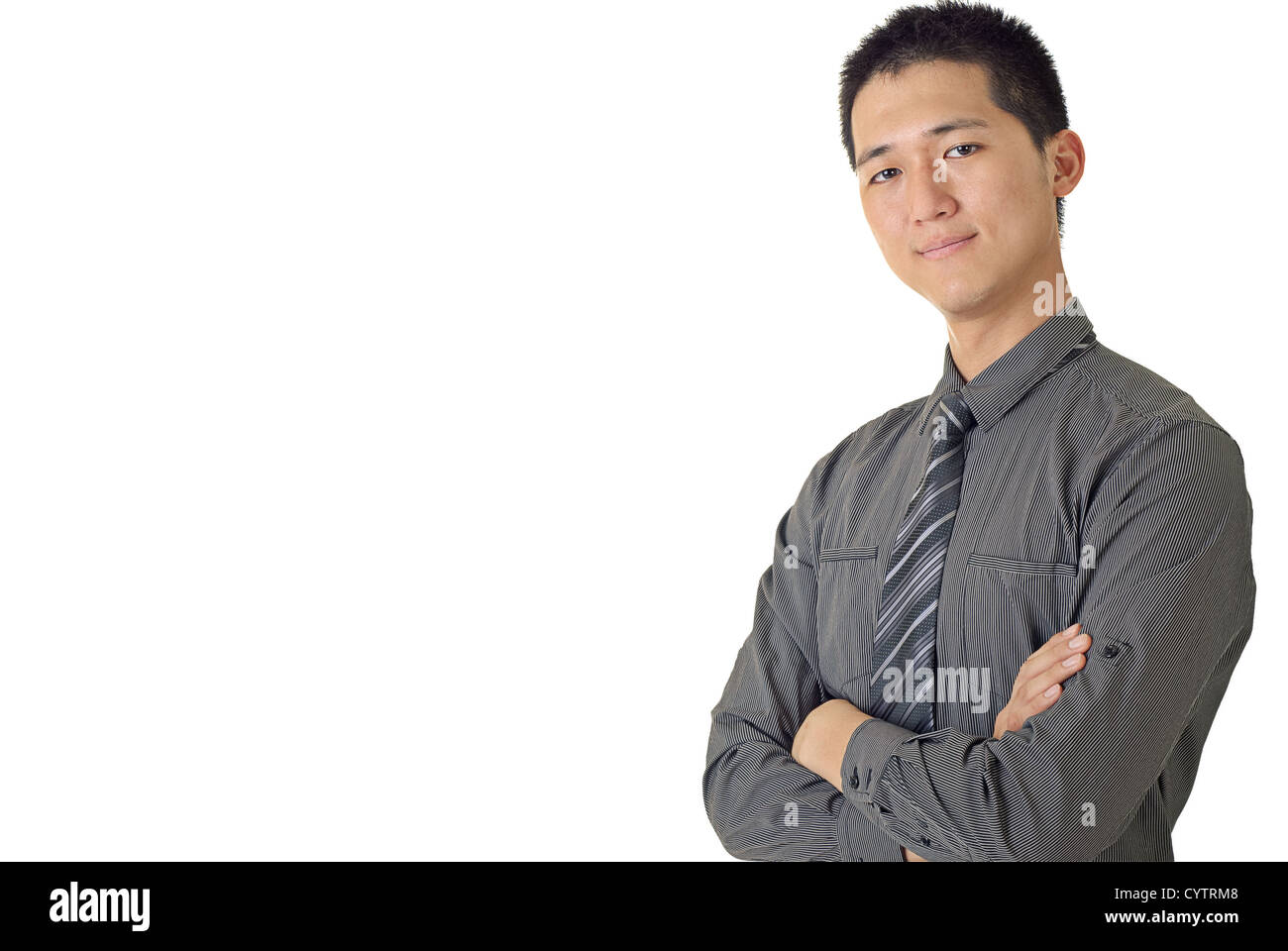 Young businessman of Asian with friendly expression on white background ...