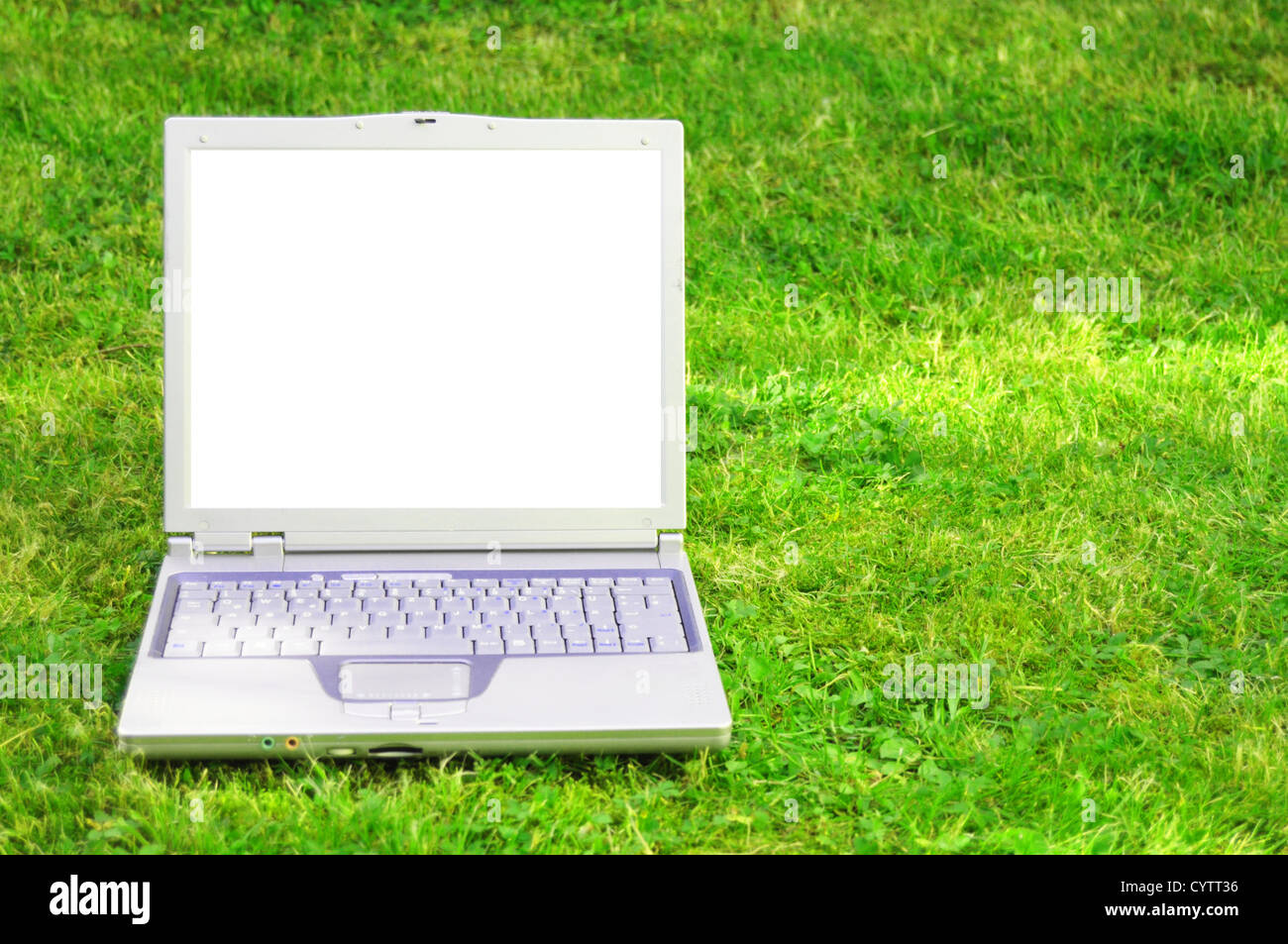 laptopn in green grass with blank or empty screen for copyspace Stock ...
