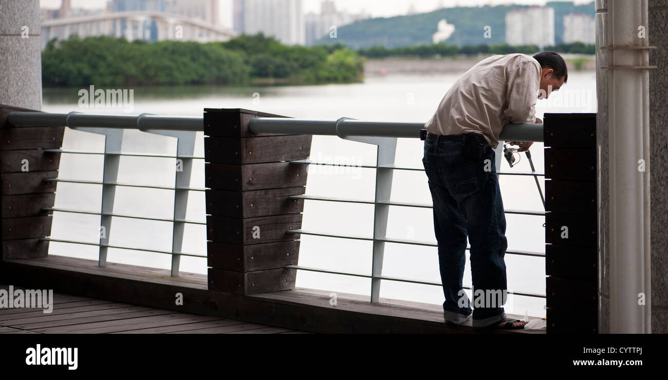 Chinese man fishing from the boardwalk,central Macau Stock Photo - Alamy