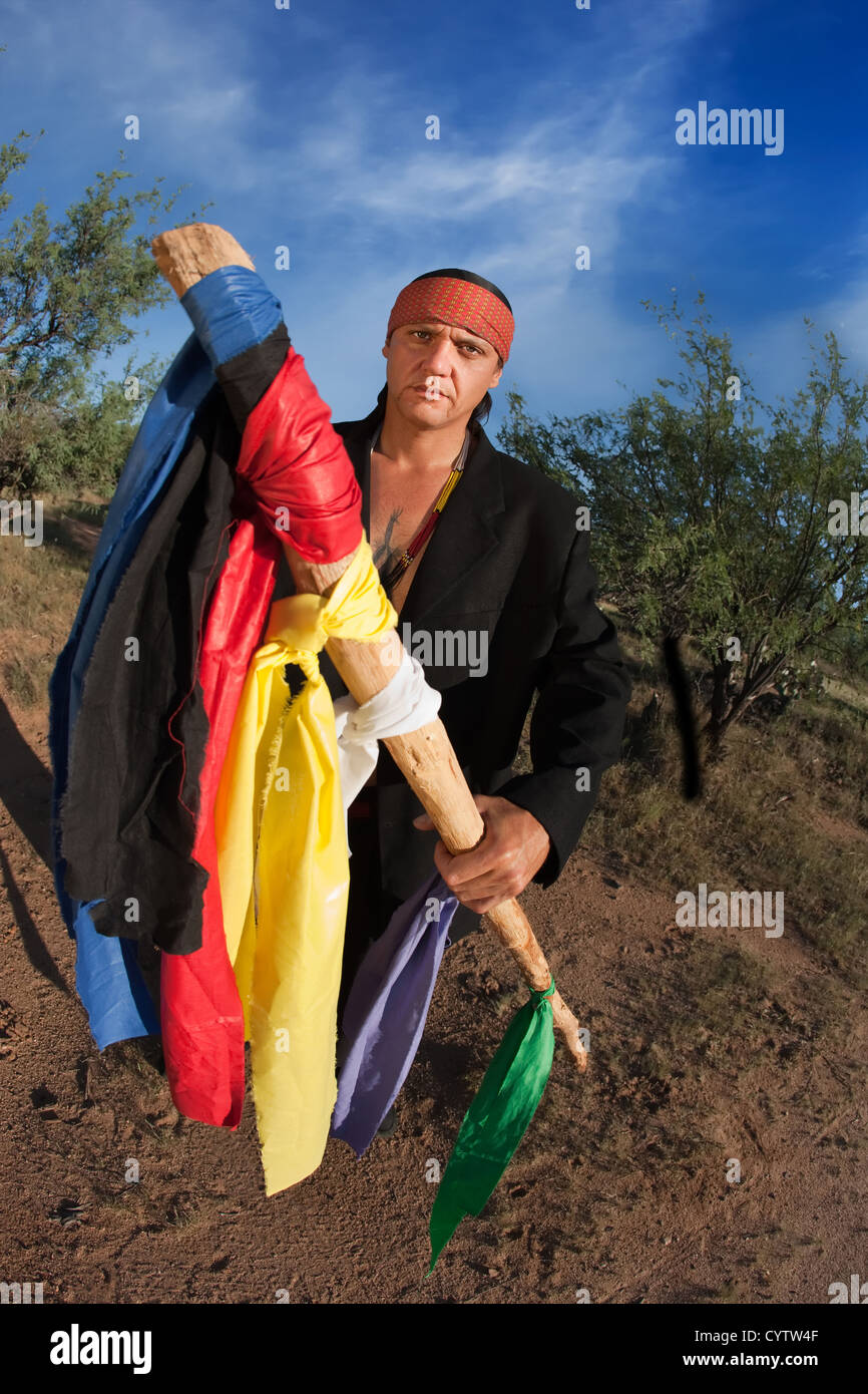 Native American man with colorful flags representing seven directions ...