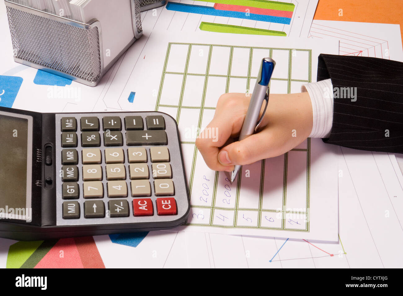 chart with calculator and pen Stock Photo - Alamy