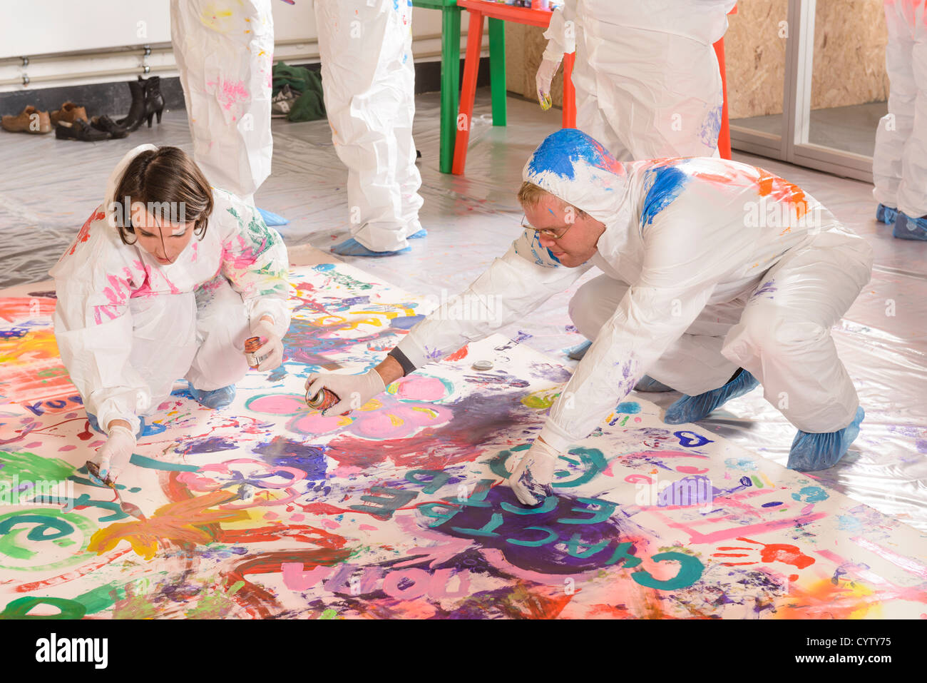 People having fun during art therapy session drawing paint Stock Photo ...