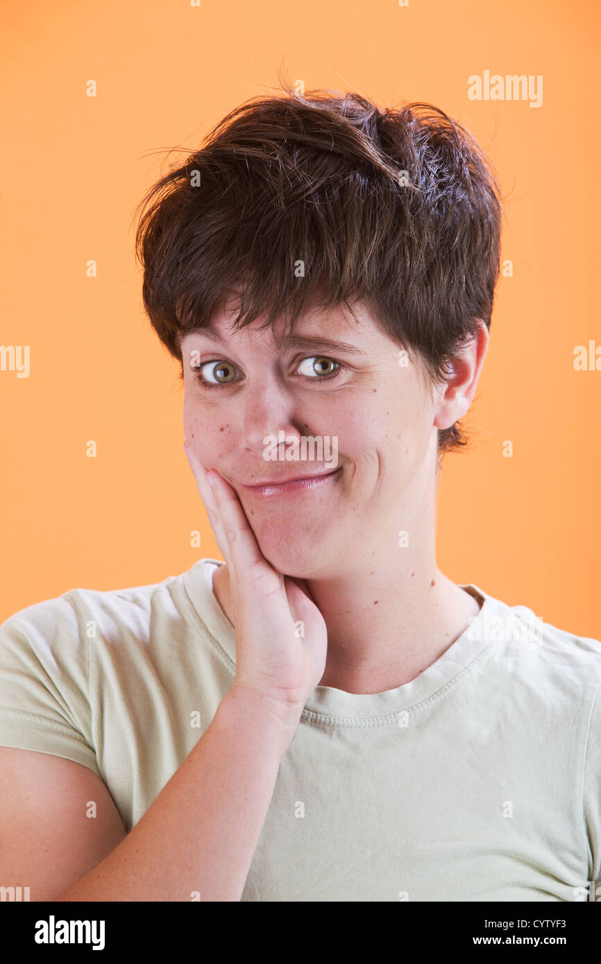 Cute young woman with a perplexed or playful look on her face Stock ...