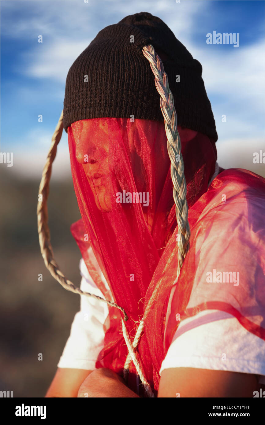 Man with strange headdress and red veil Stock Photo - Alamy