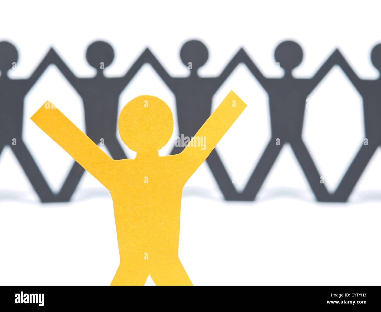 A yellow paper figure raising his arms. A paper man chain against the ...