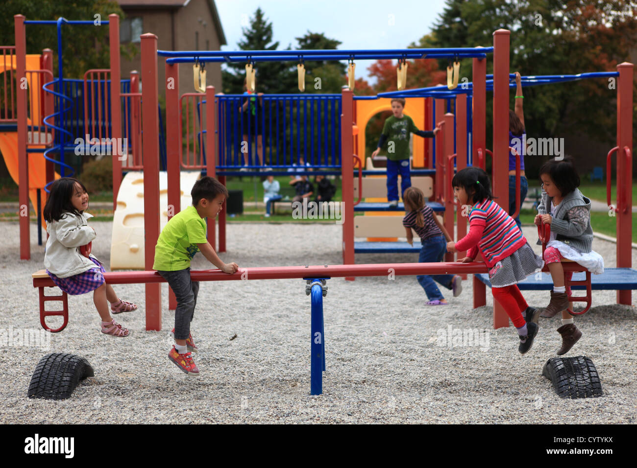 Children playing on teeter totter hi-res stock photography and images ...