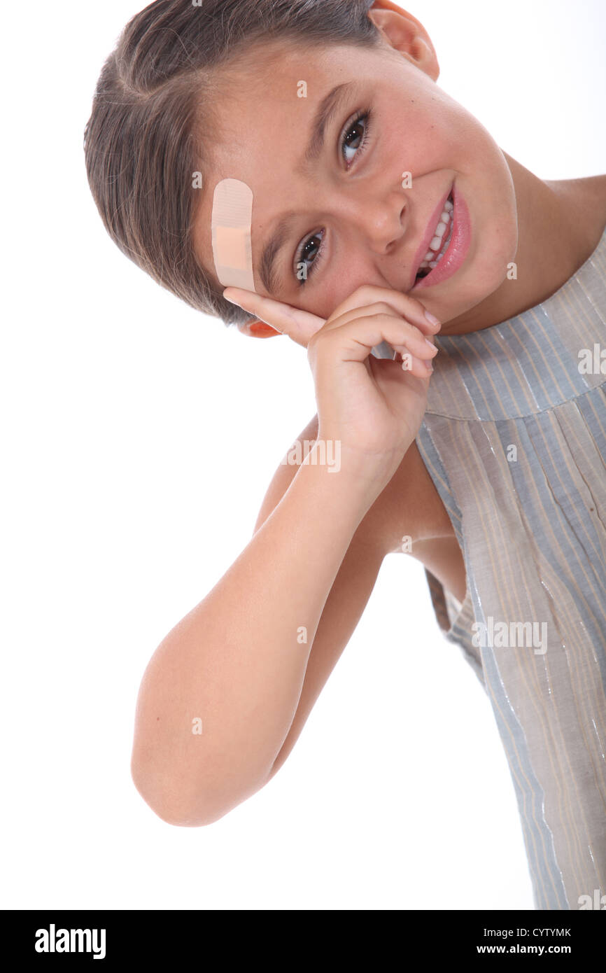 Girl with a plaster on forehead Stock Photo - Alamy