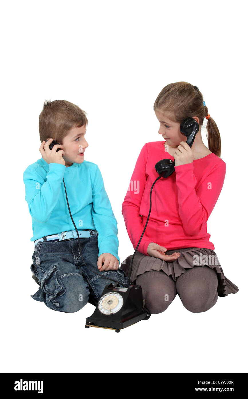 Kids using old-fashioned telephone Stock Photo - Alamy