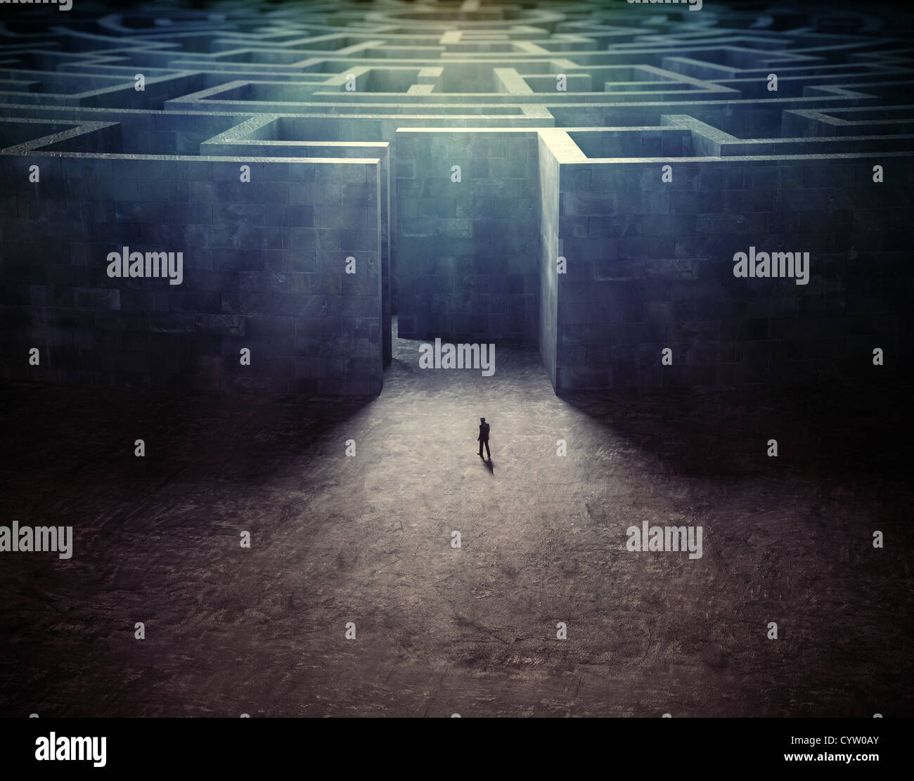 Tiny man entering a mysterious maze Stock Photo - Alamy