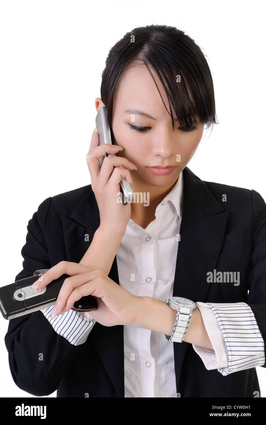 Busy business woman holding cellphones and watching watch, closeup ...