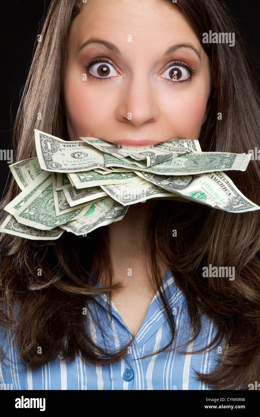 Woman eating money in mouth Stock Photo - Alamy