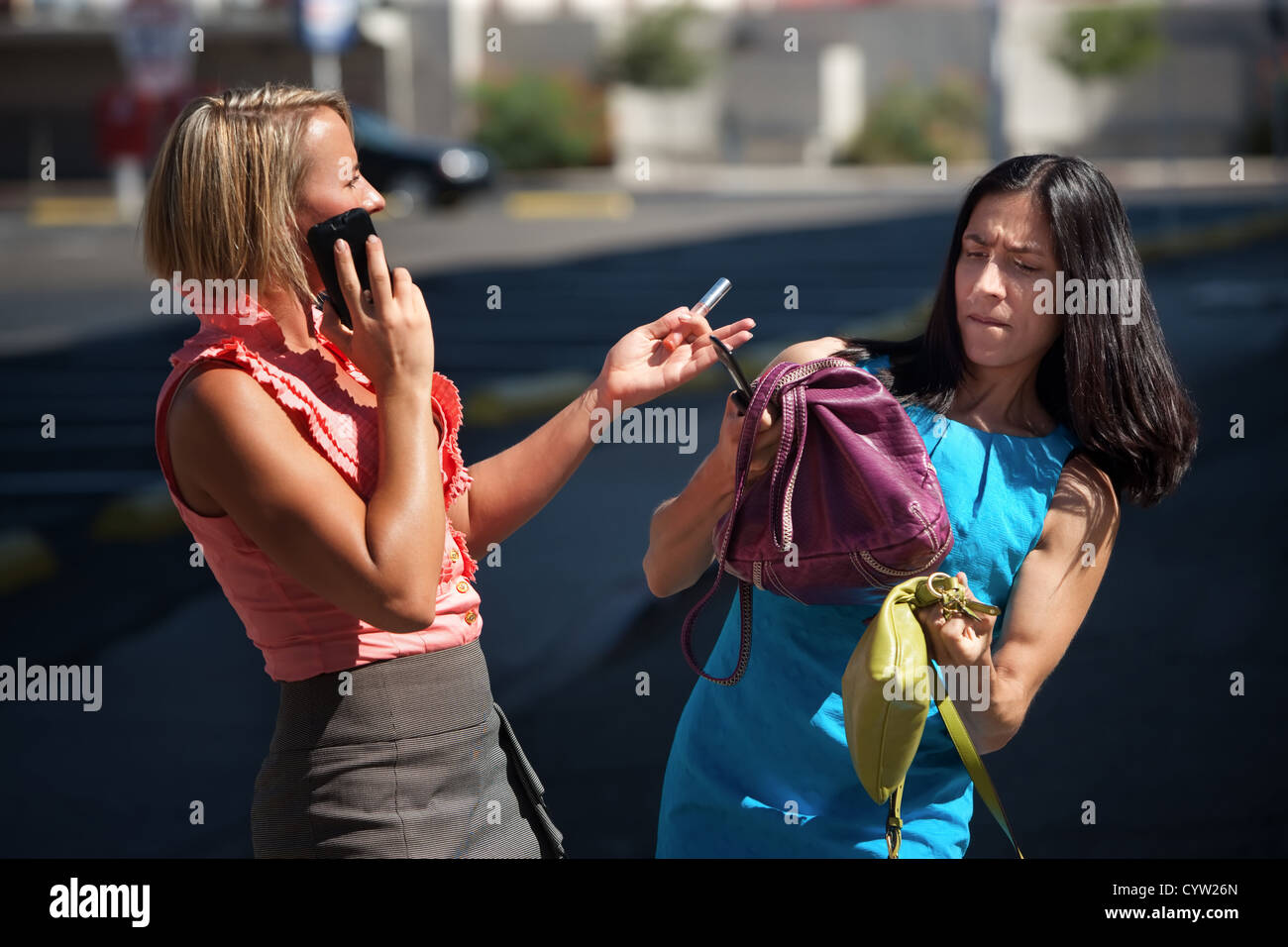Two friends juggle multiple tasks on city street Stock Photo - Alamy Two friends juggle multiple tasks on city street Stock Photo - Alamy