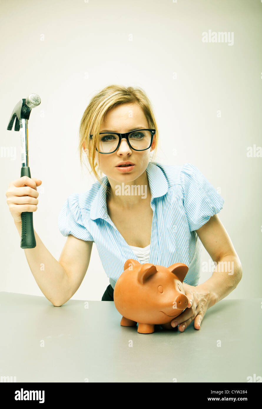 breaking a piggy bank Stock Photo - Alamy