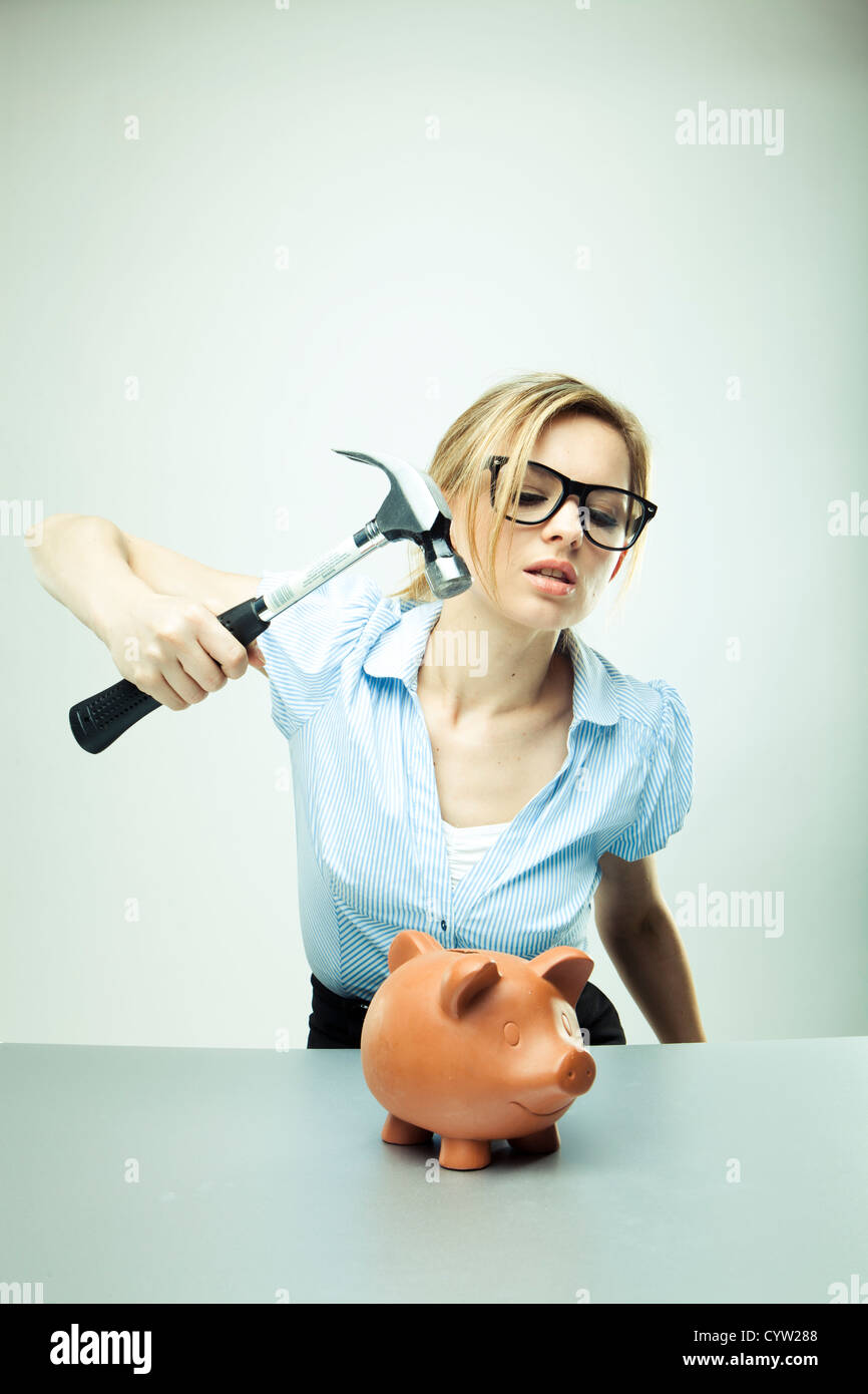 breaking a piggy bank Stock Photo - Alamy