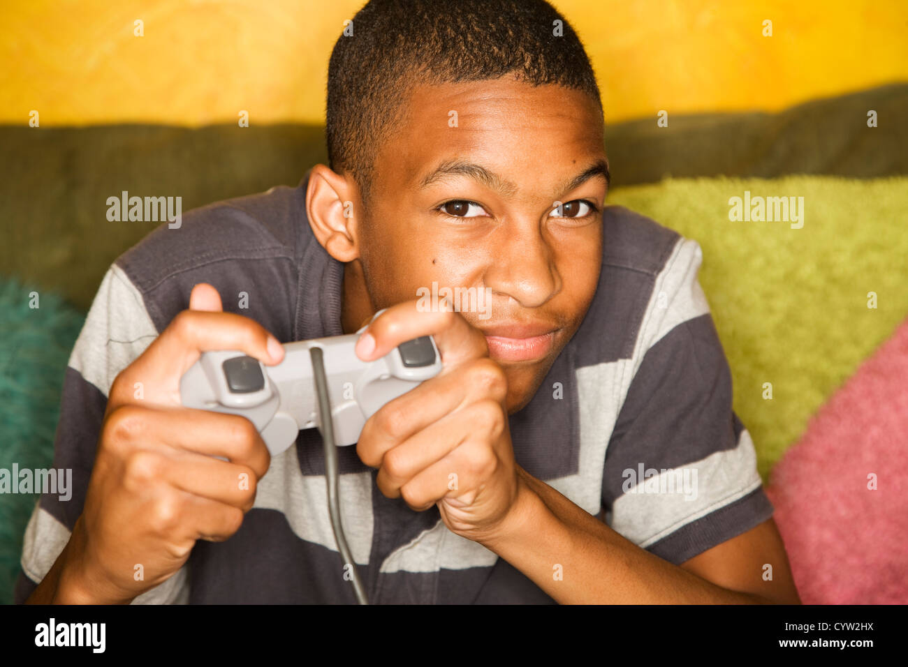 Handsome young man Playing a Video Game with Handheld Controller Stock ...